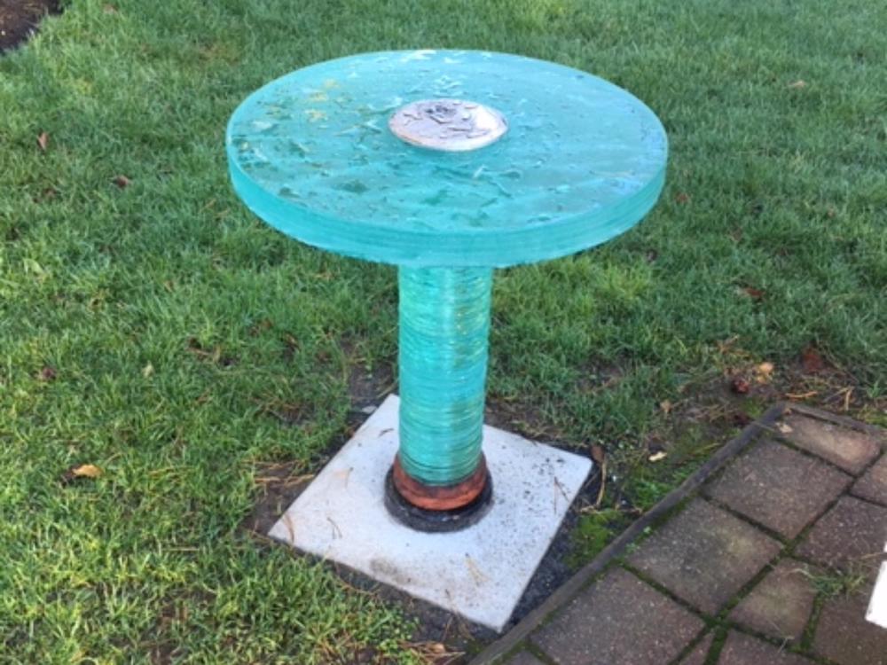 Vandalised commerorative glass table - Givealittle